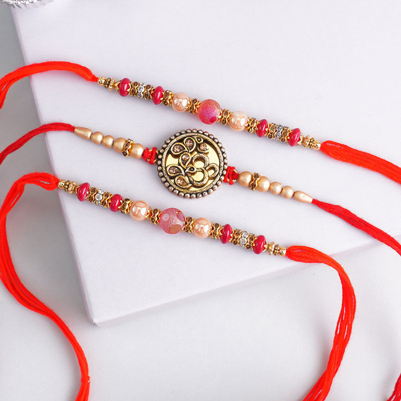 Send Eye-catchy golden Rakhi set of 3 Online