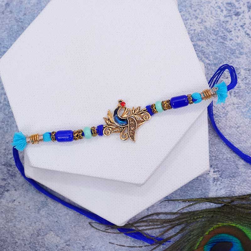 Send Golden Peacock and Ganesha Rakhi Set Online