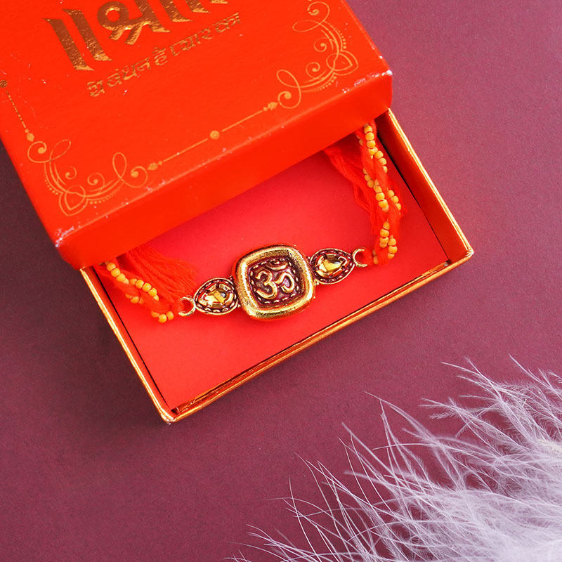 Send Sacred om Gold Rakhi for brother Online