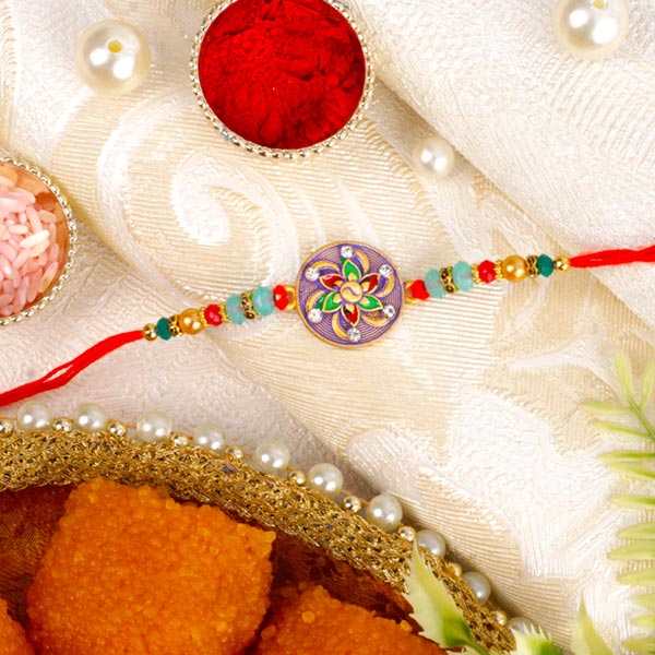 Send Round Floral Rakhi with Motichoor Ladoo Online